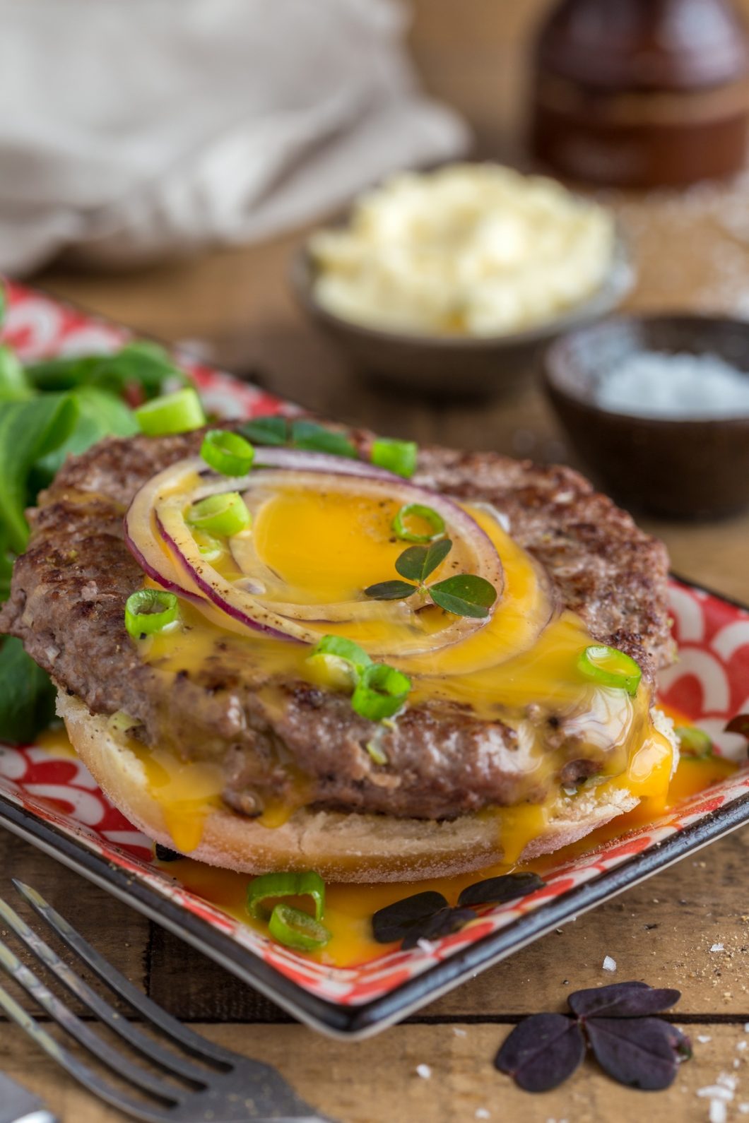 Beef patty open sandwich with raw egg yolk • Electric Blue Food